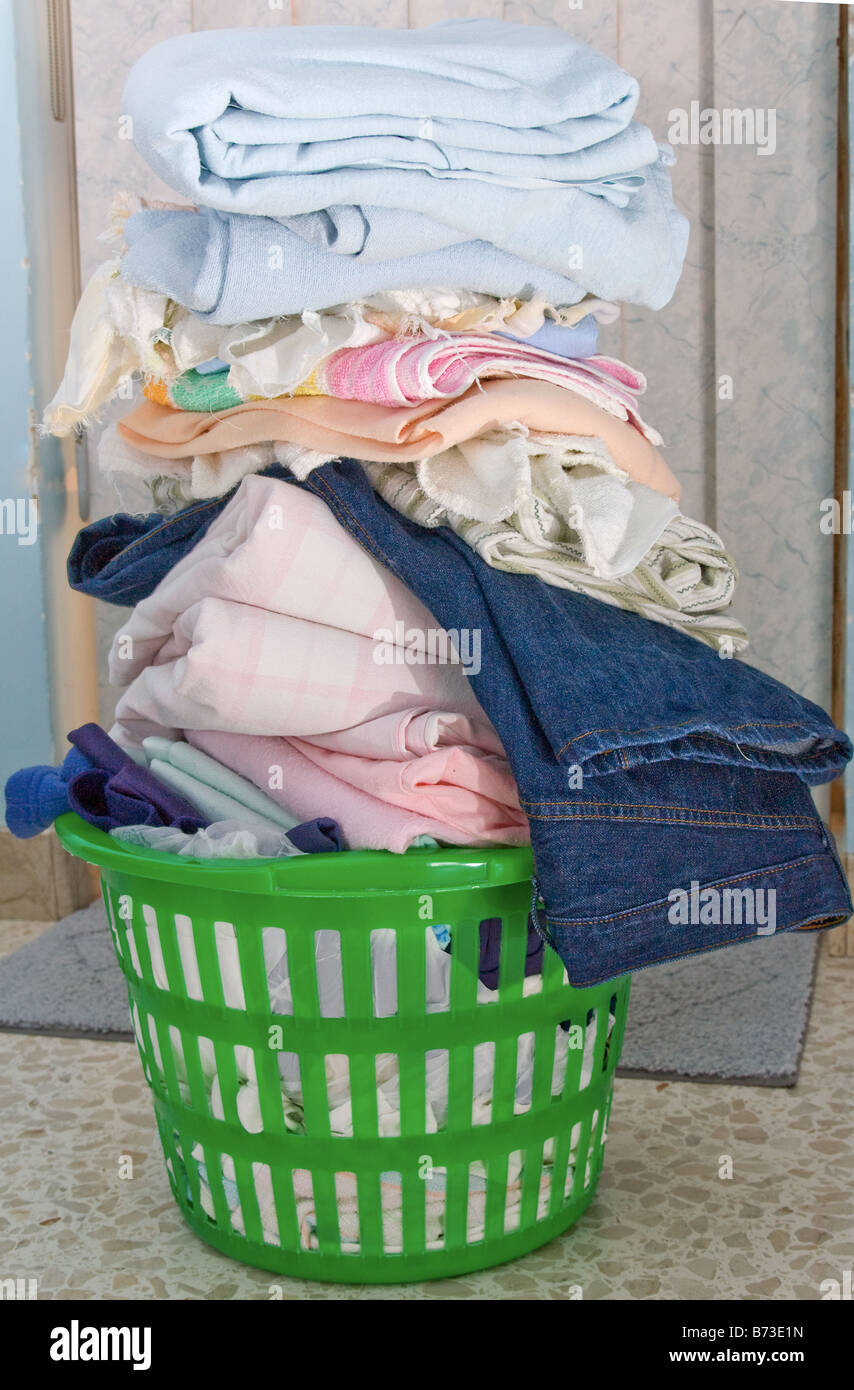Overflowing washing basket Stock Photo - Alamy