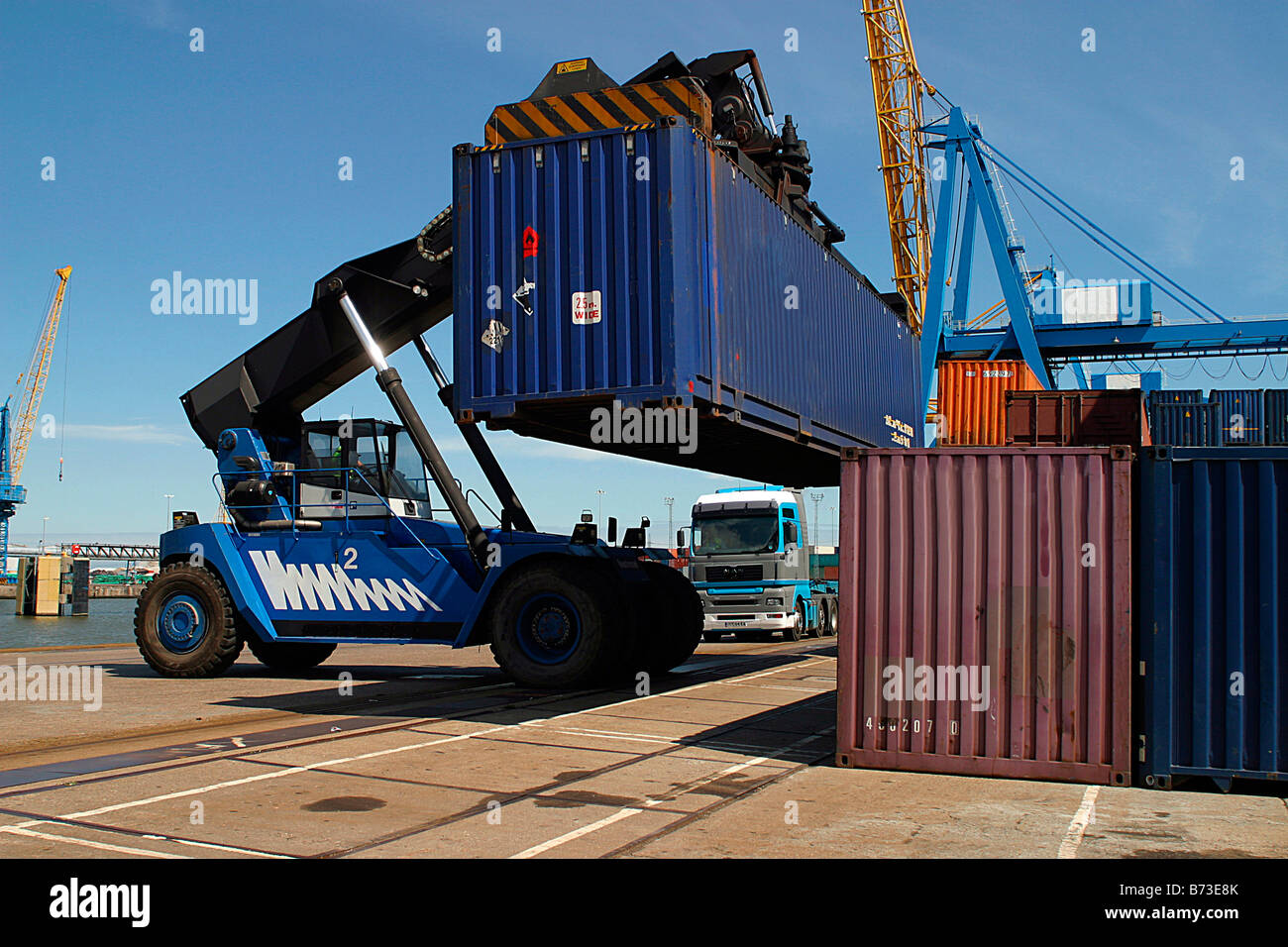 Shipping container loading onto truck Stock Photo - Alamy
