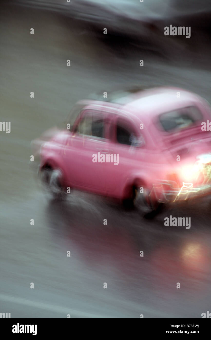 fast pink fiat 500 car driving in heavy rain in rome italy Stock Photo ...
