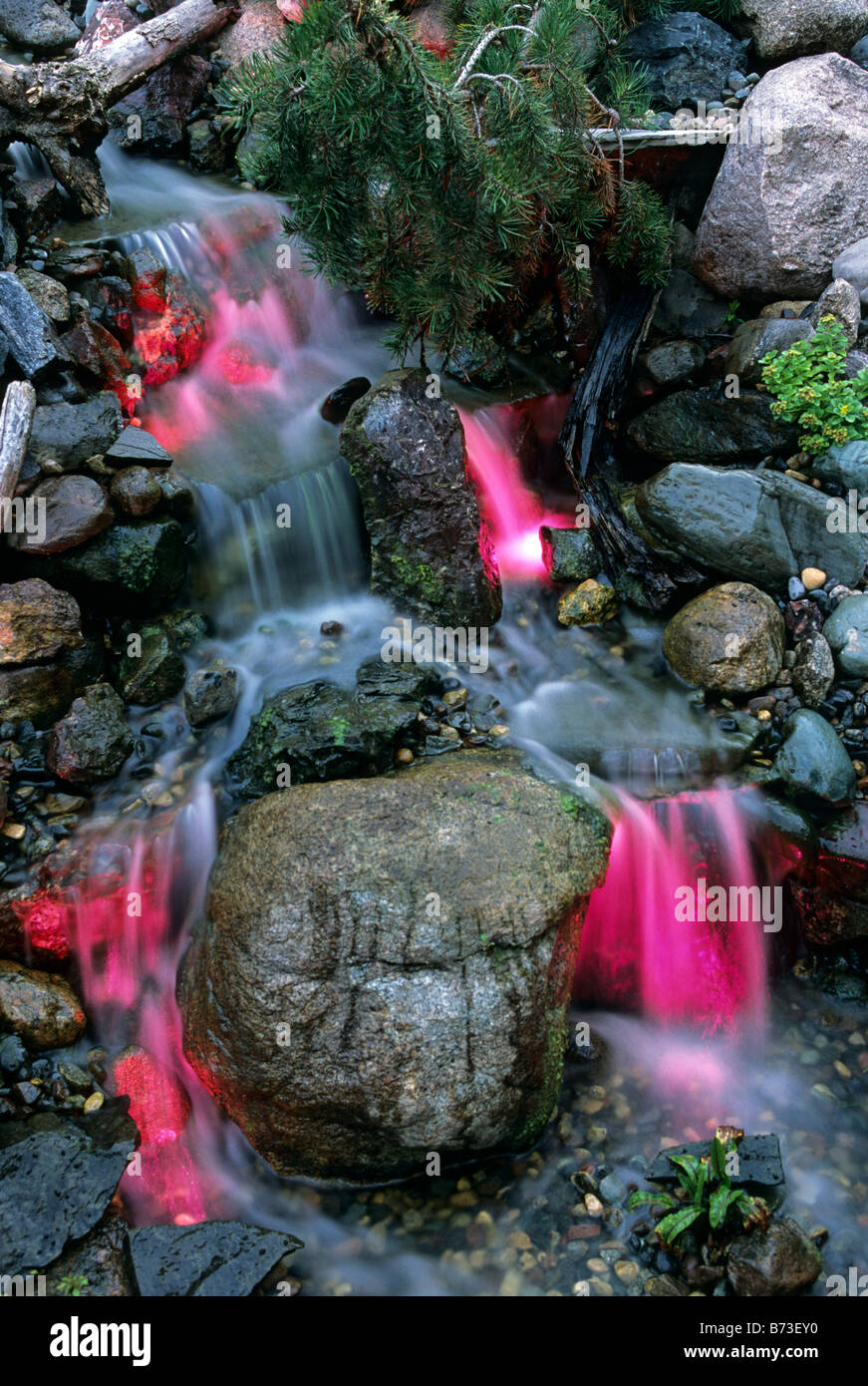 CHANGING COLORS BELOW GARDEN WATERFALLS CREATED BY UNDERWATER FIBER ...