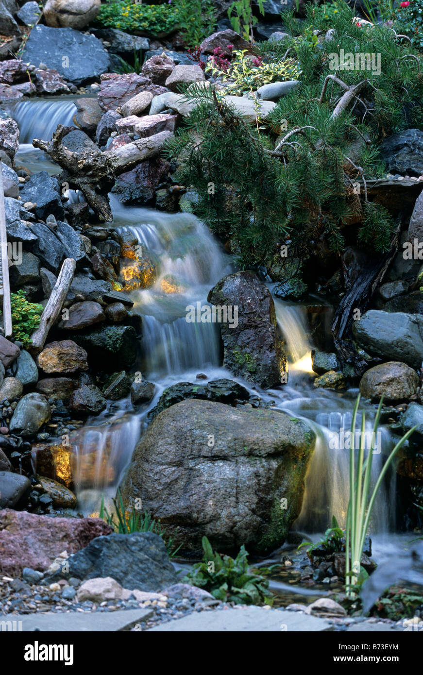 CHANGING COLORS BENEATH NATURAL STONE WATERFALLS CREATED BY FIBER OPTIC ...