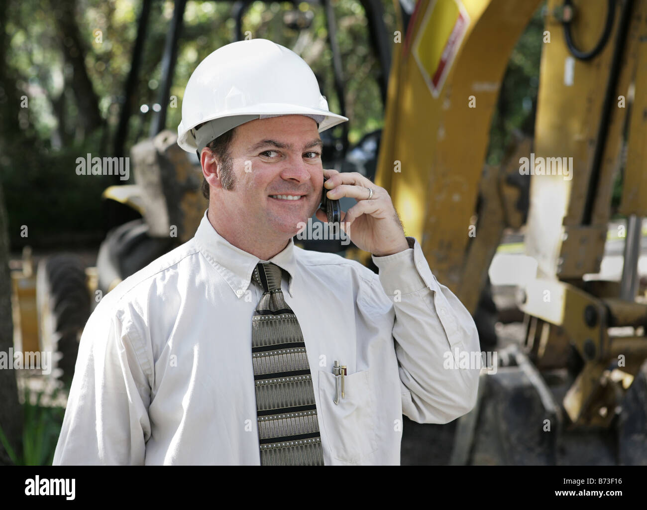 An engineer on the construction site talking on the phone Stock Photo ...