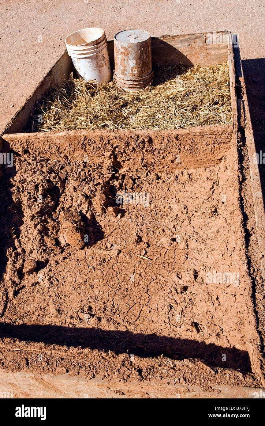 Image of an adobe brick making double form with one side ready for ...