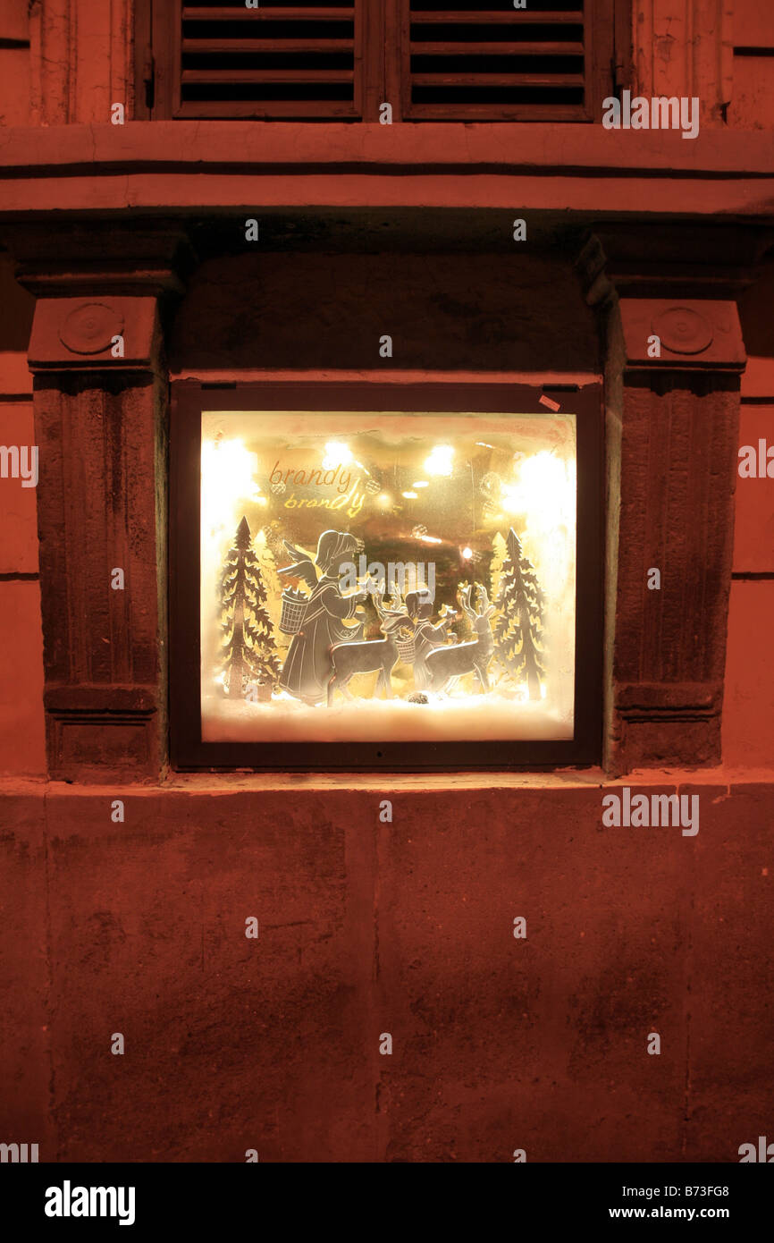 angels with gifts at christ nativity scene in shop window at night ...