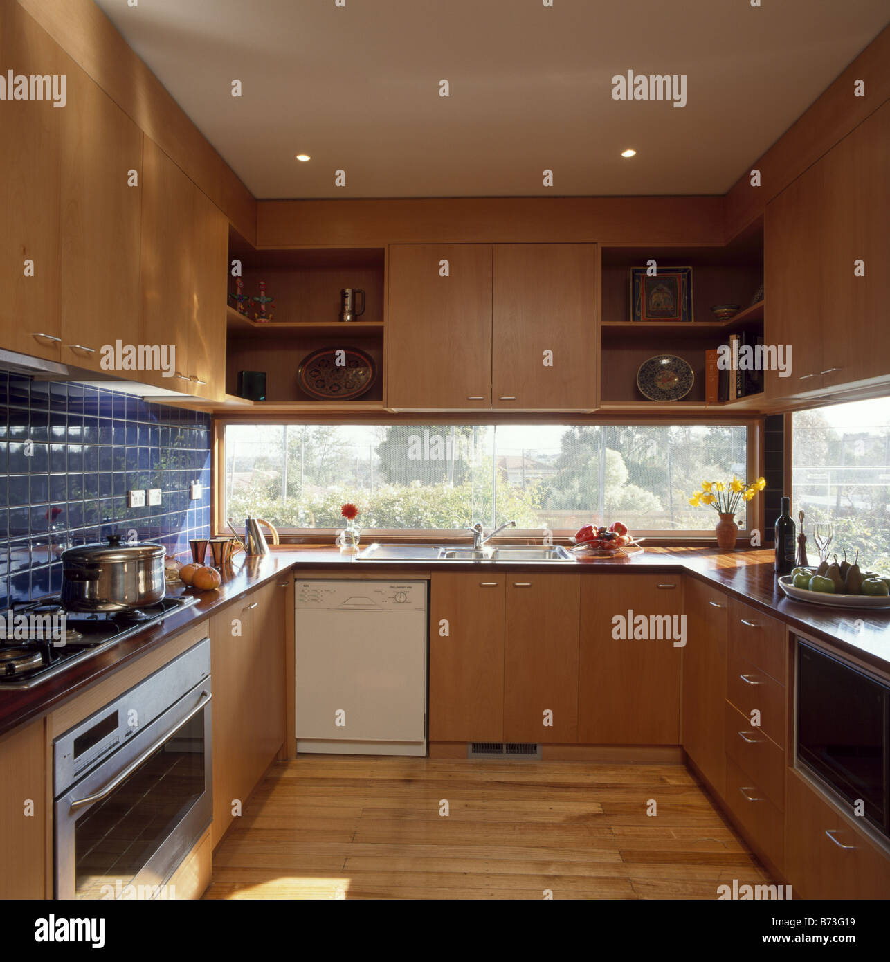 Dishwasher in simple wooden units in modern kitchen with wooden ...