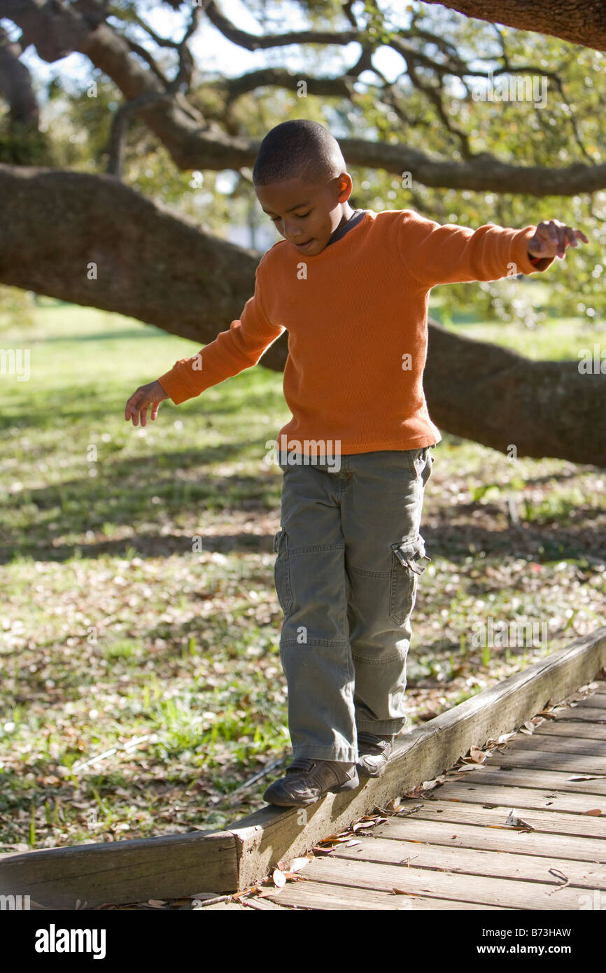 Young African American boy balancing on board outdoors in park Stock ...