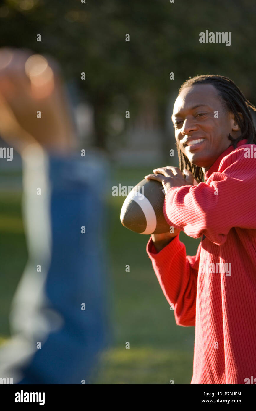 African American man throwing football in park Stock Photo - Alamy
