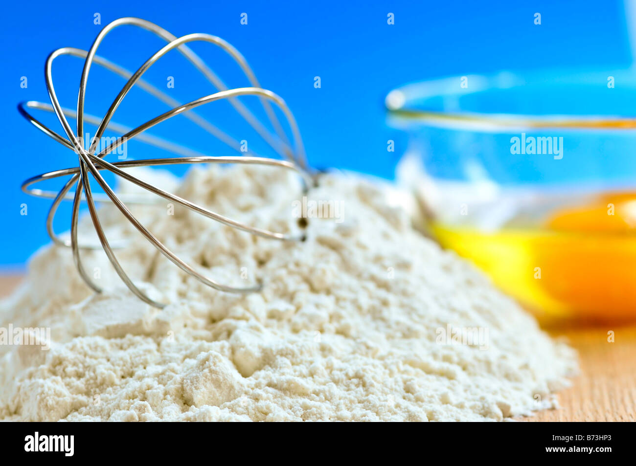 Flour whisk and eggs in a bowl baking ingredients Stock Photo - Alamy