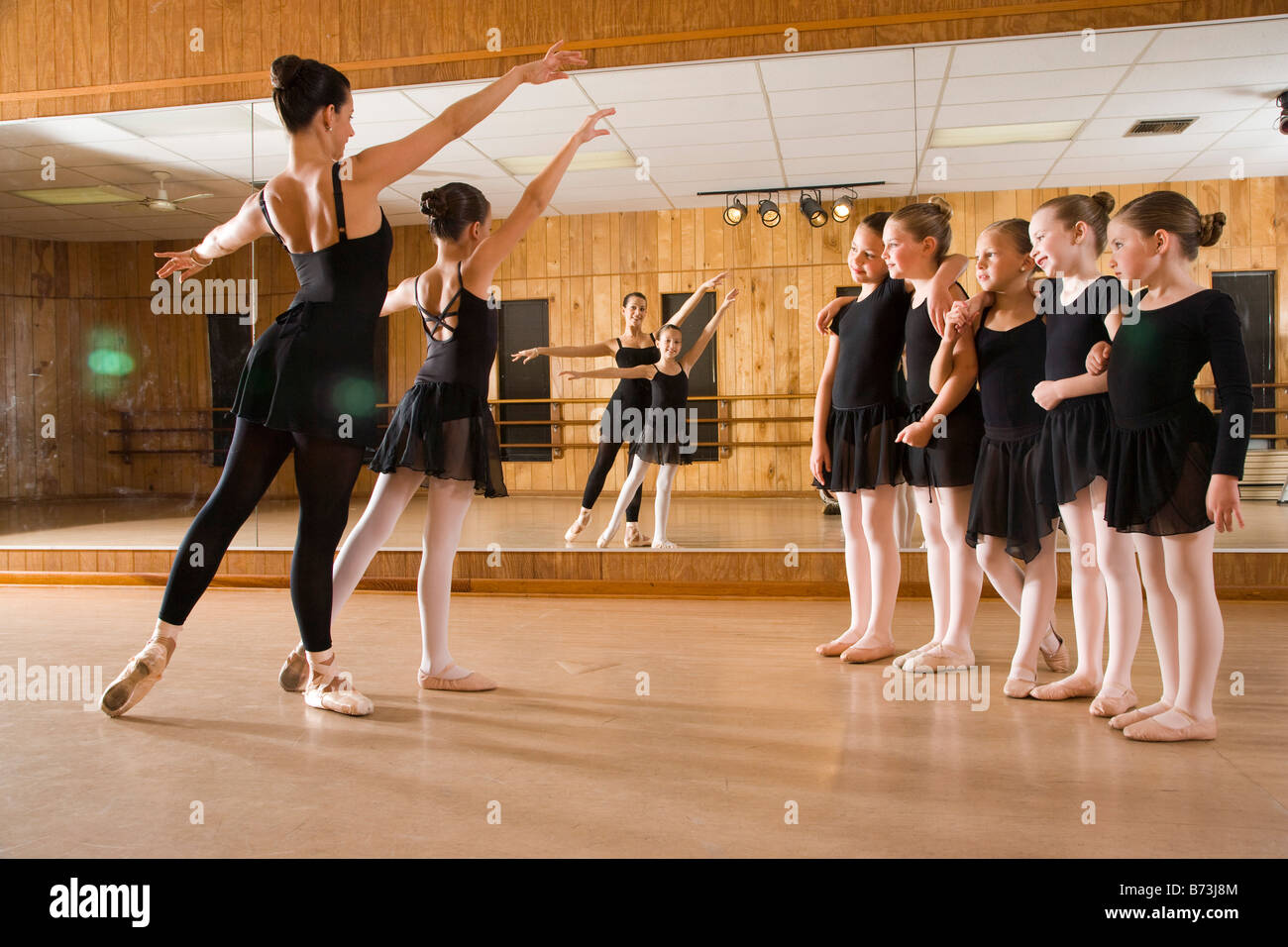 Young ballerinas with dance instructor in studio Stock Photo - Alamy