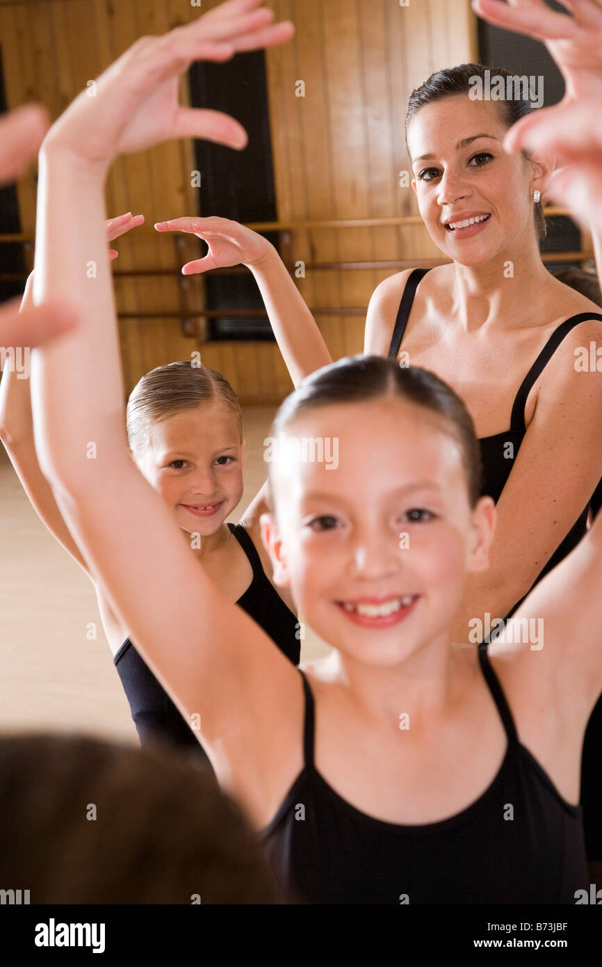 Young ballerinas with teacher in dance studio having lesson Stock Photo ...
