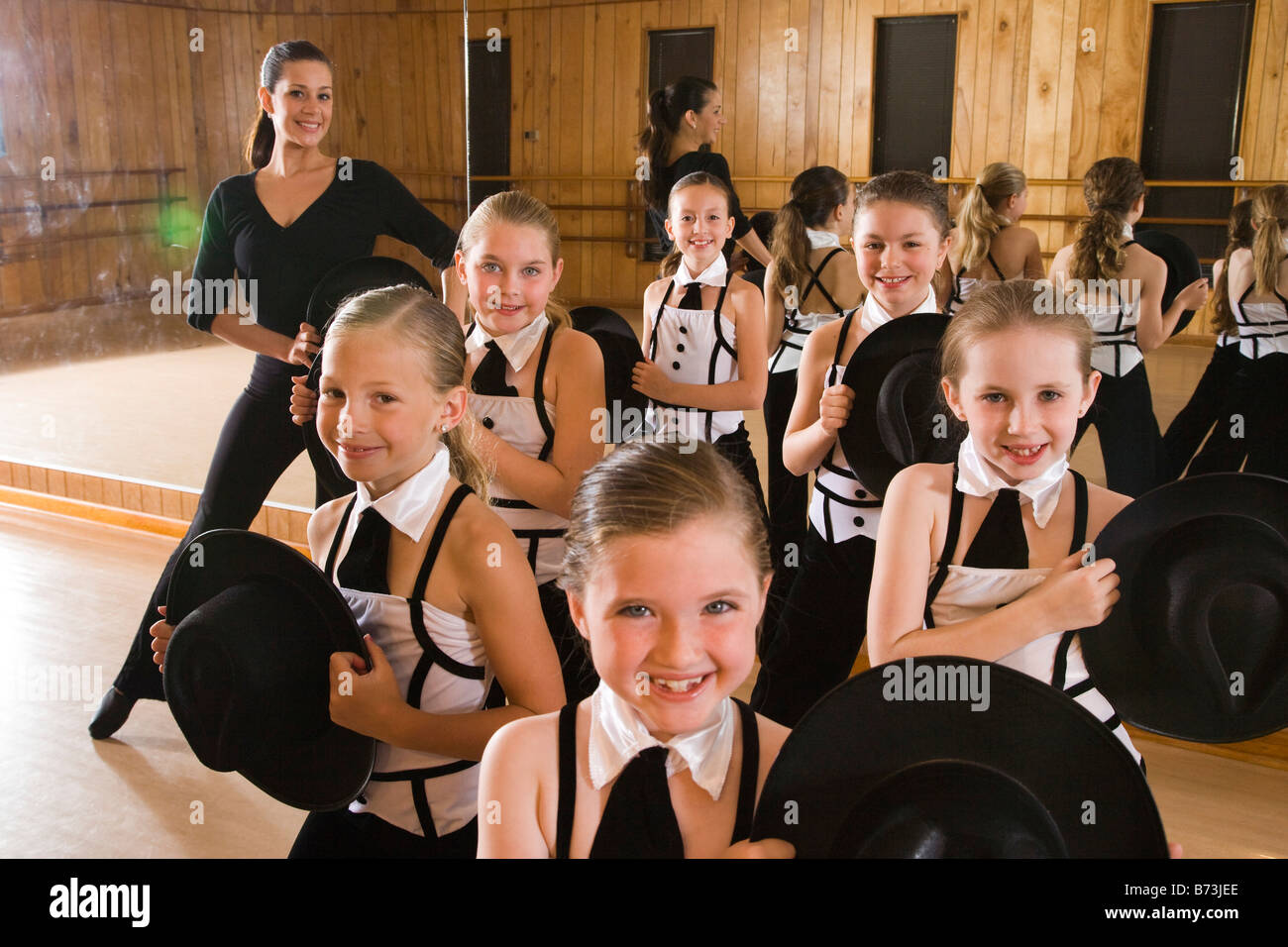 Group of girls in costume rehearsing in dance studio with teacher Stock ...