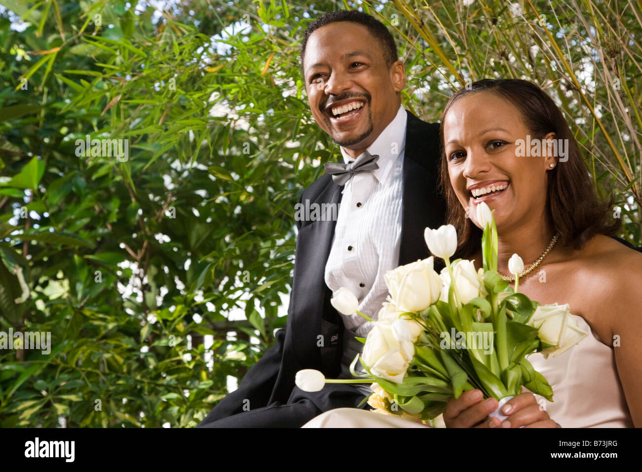 Happy African-American bride and groom outdoors on wedding day Stock ...