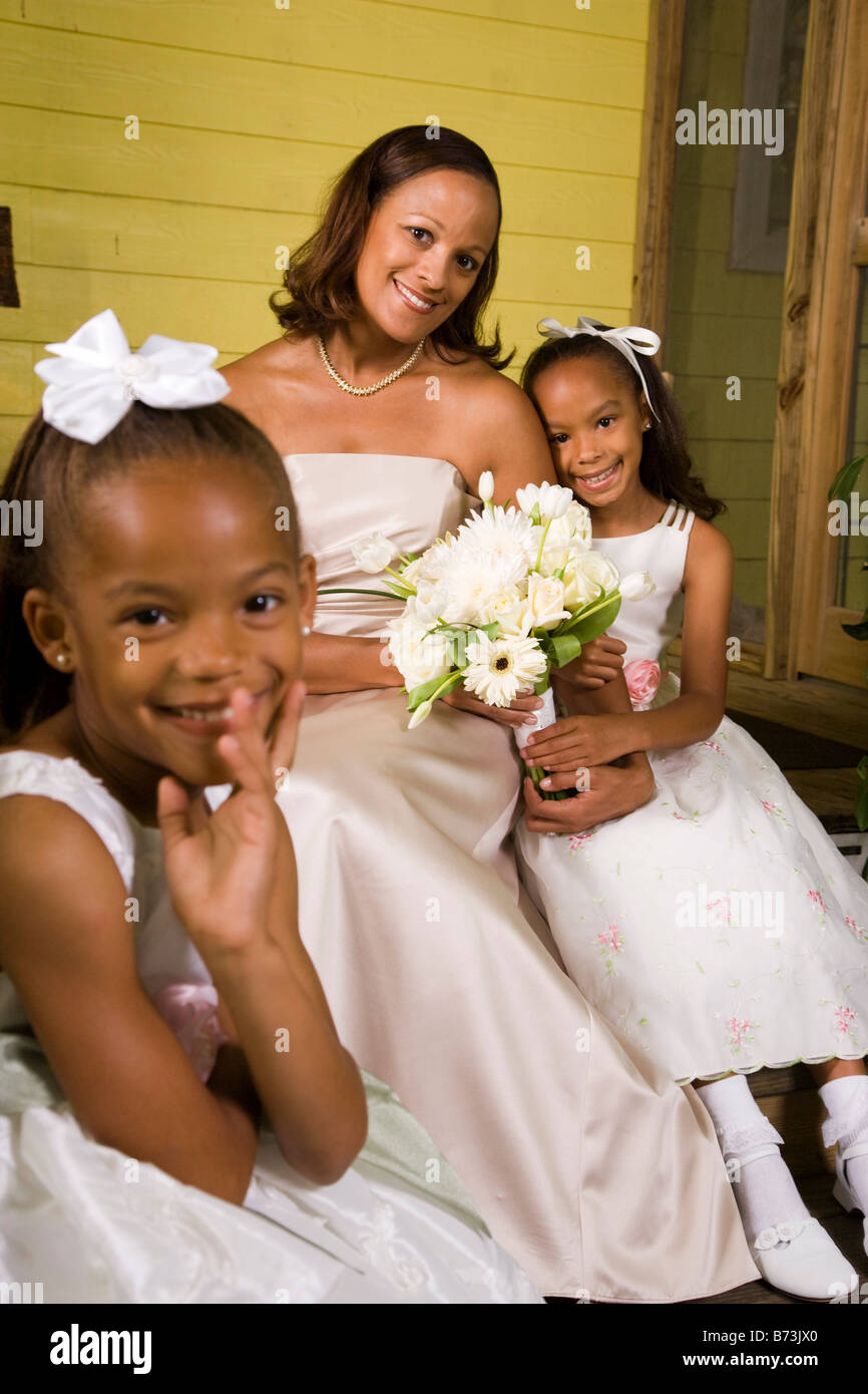 Cute little flower girls with bride in background Stock Photo - Alamy