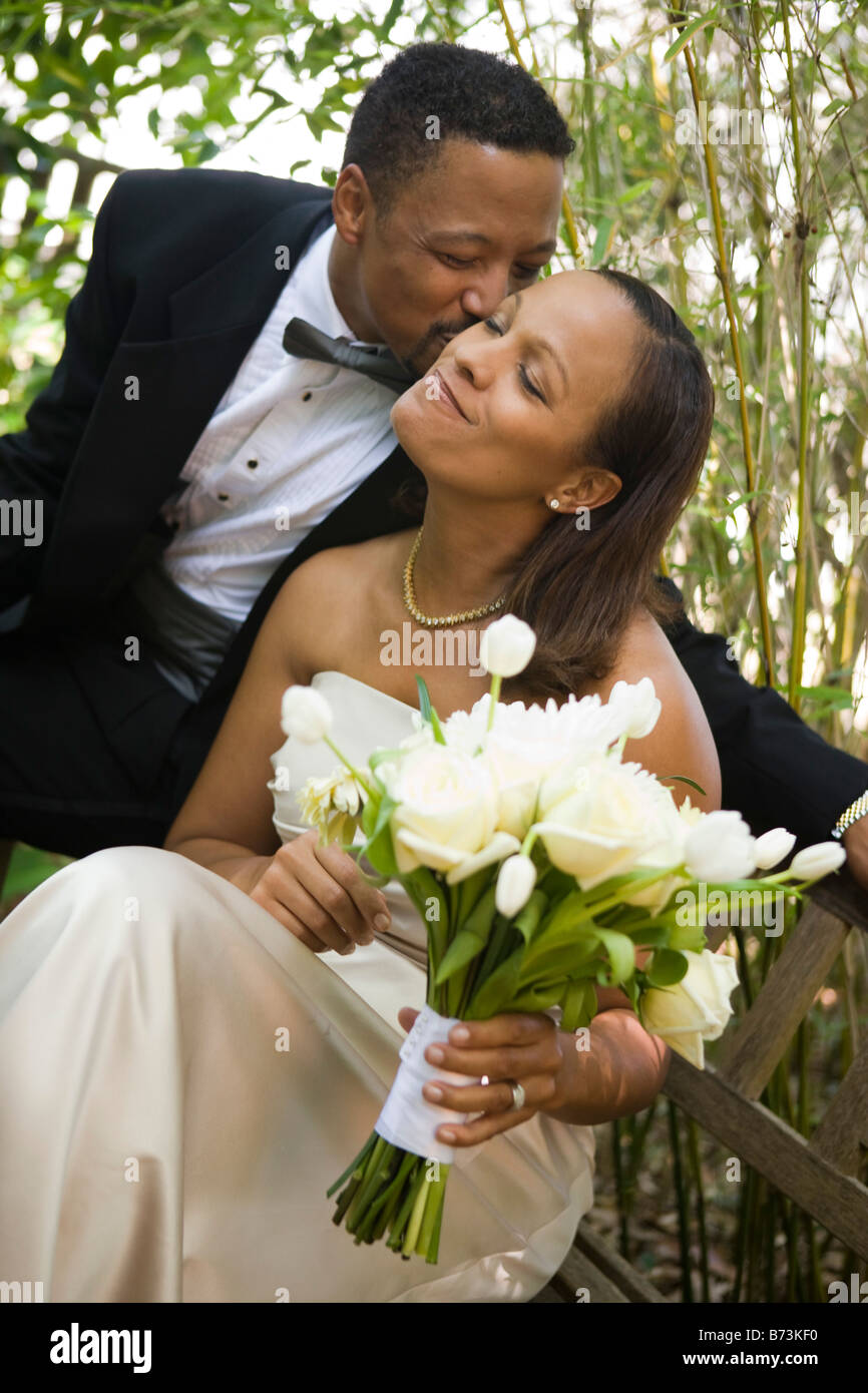 Happy African-American groom kissing his bride outdoors Stock Photo - Alamy