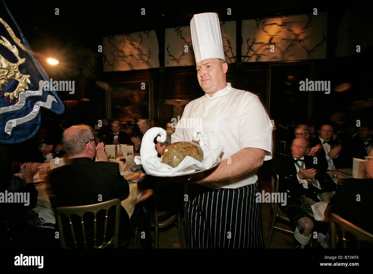 The chef brings in the haggis at a traditional Burns Night dinner Stock ...