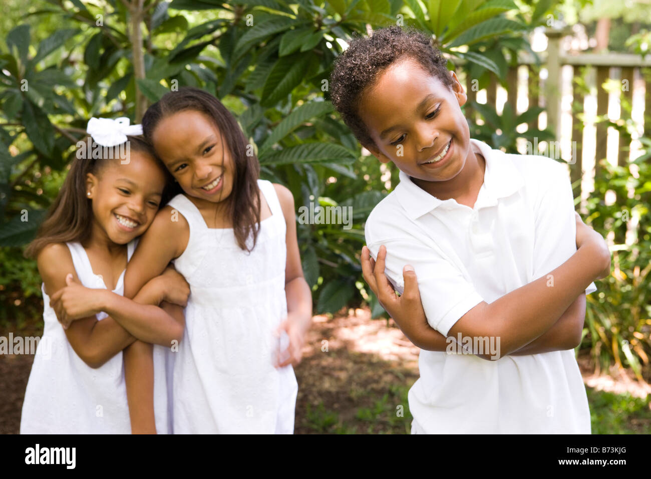Three friends standing in embrace hi-res stock photography and images ...