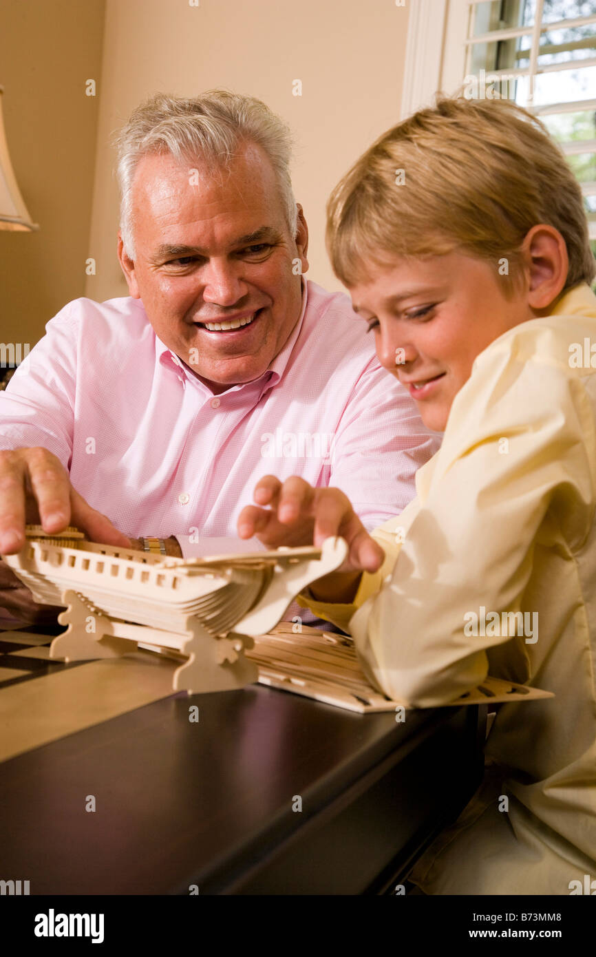 Son and father model building together hi-res stock photography and ...