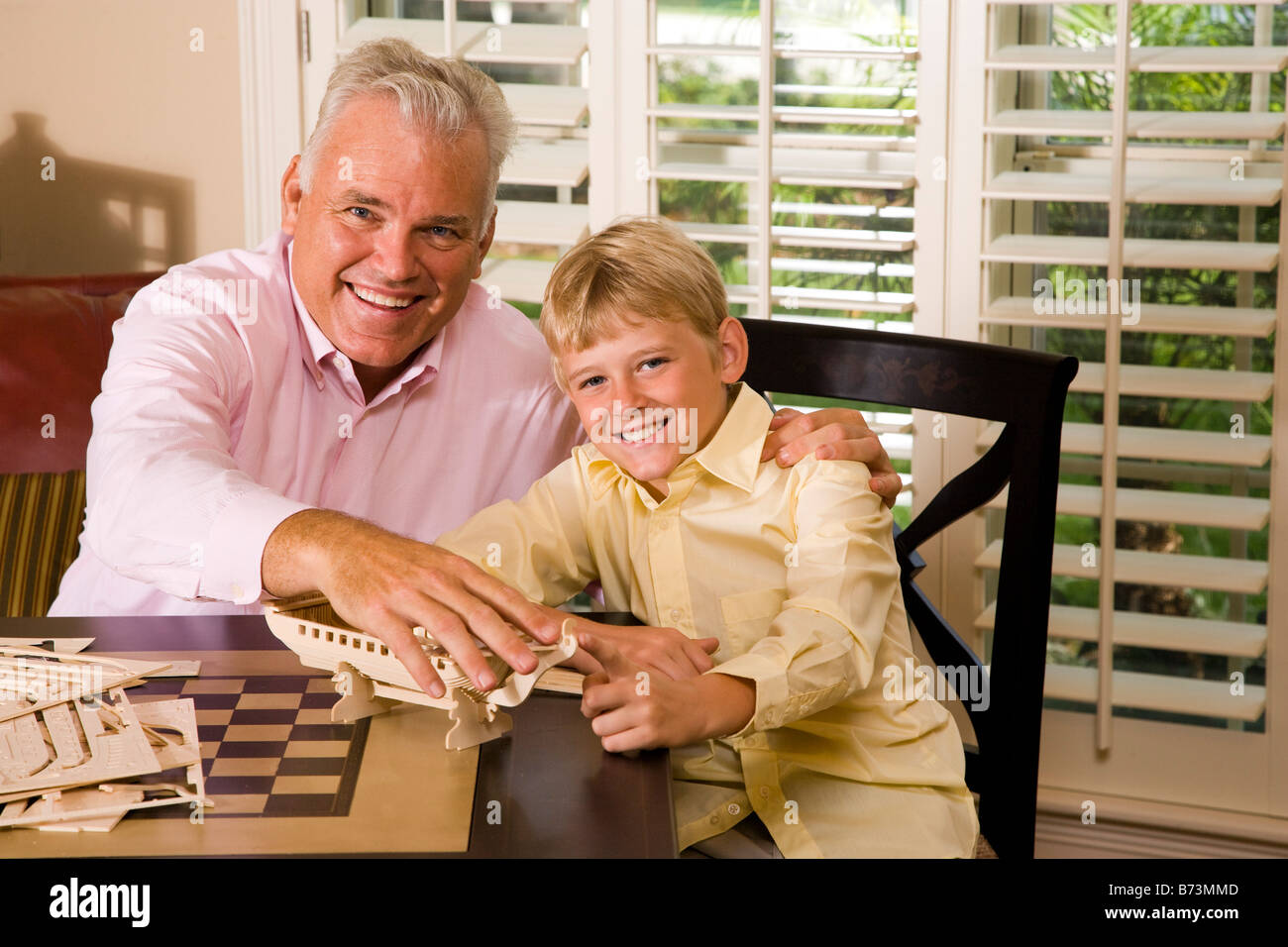 Father and son putting together a toy model Stock Photo - Alamy
