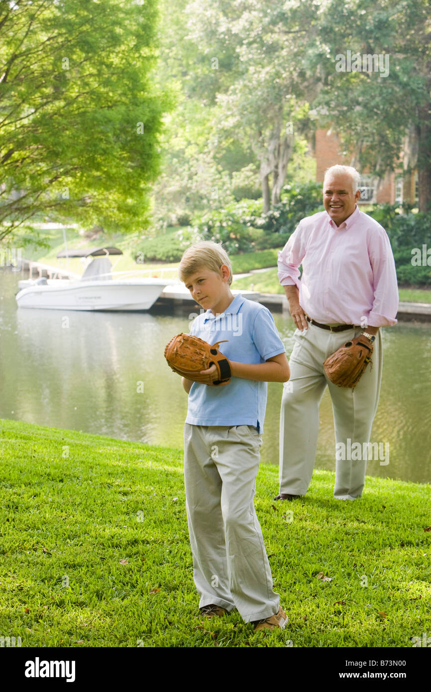 Grandfather and son playing baseball in back yard Stock Photo - Alamy