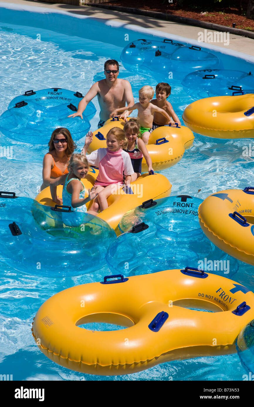Family and friends floating on innertubes at a water park Stock Photo ...