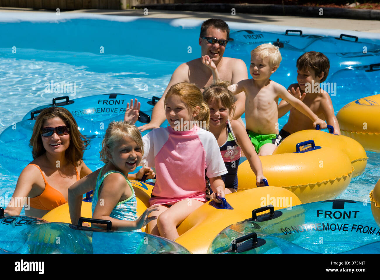 Family and friends floating on innertubes at a water park Stock Photo ...