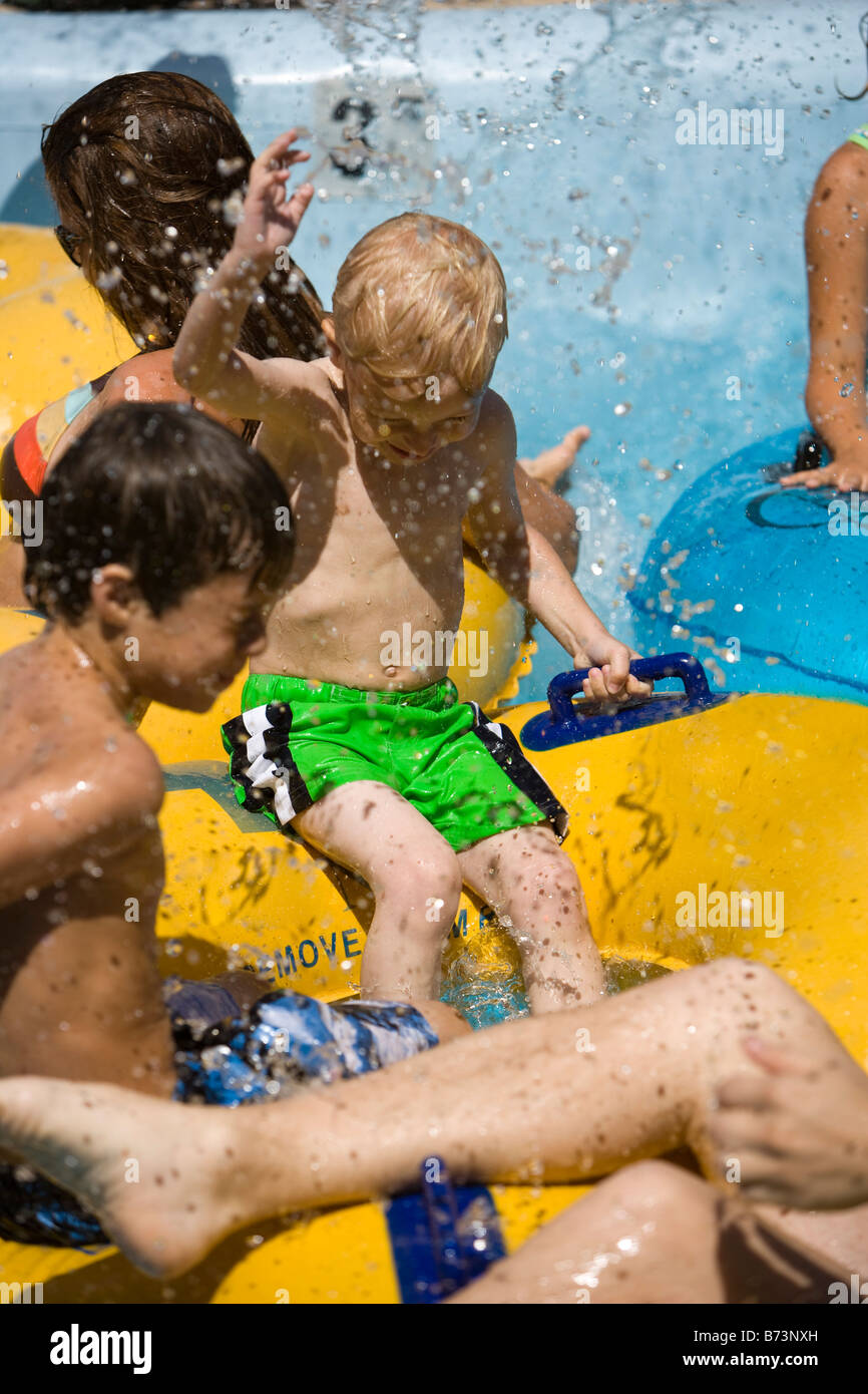 Children having fun splashing at water park Stock Photo - Alamy