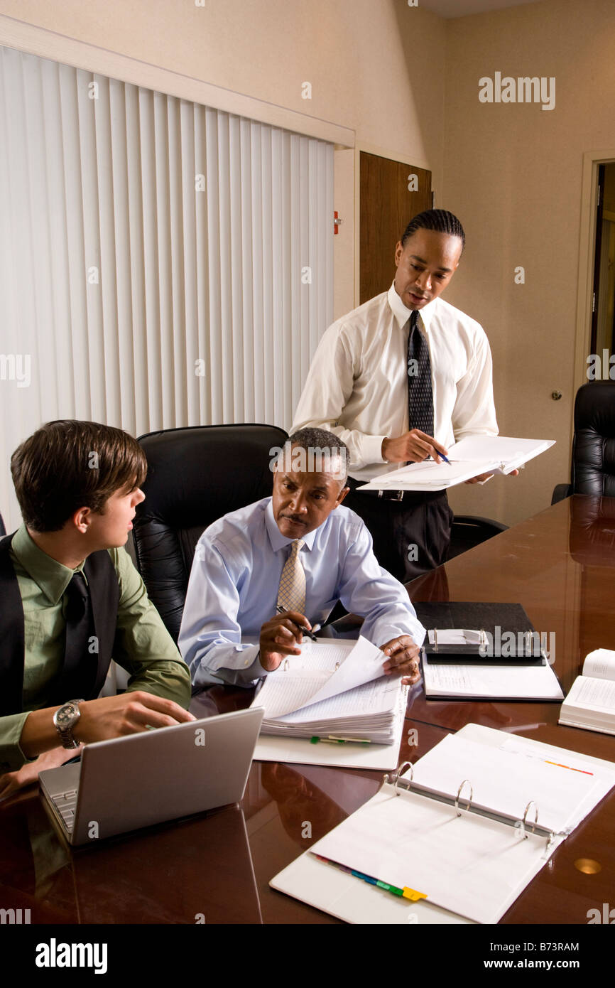 African-American executive and two younger colleagues reviewing ...