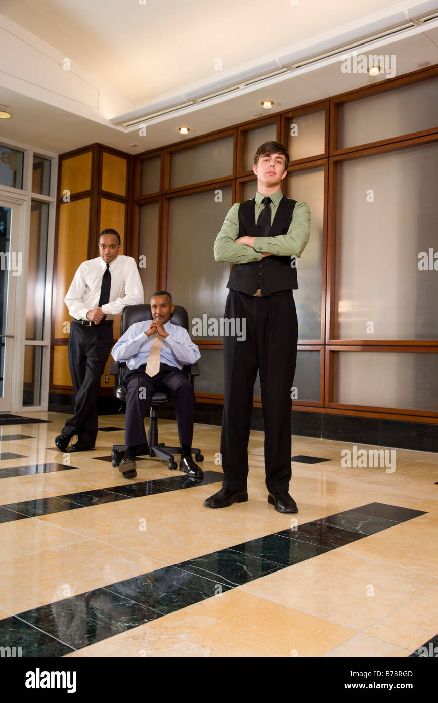 Executive and employees meeting in lobby Stock Photo - Alamy