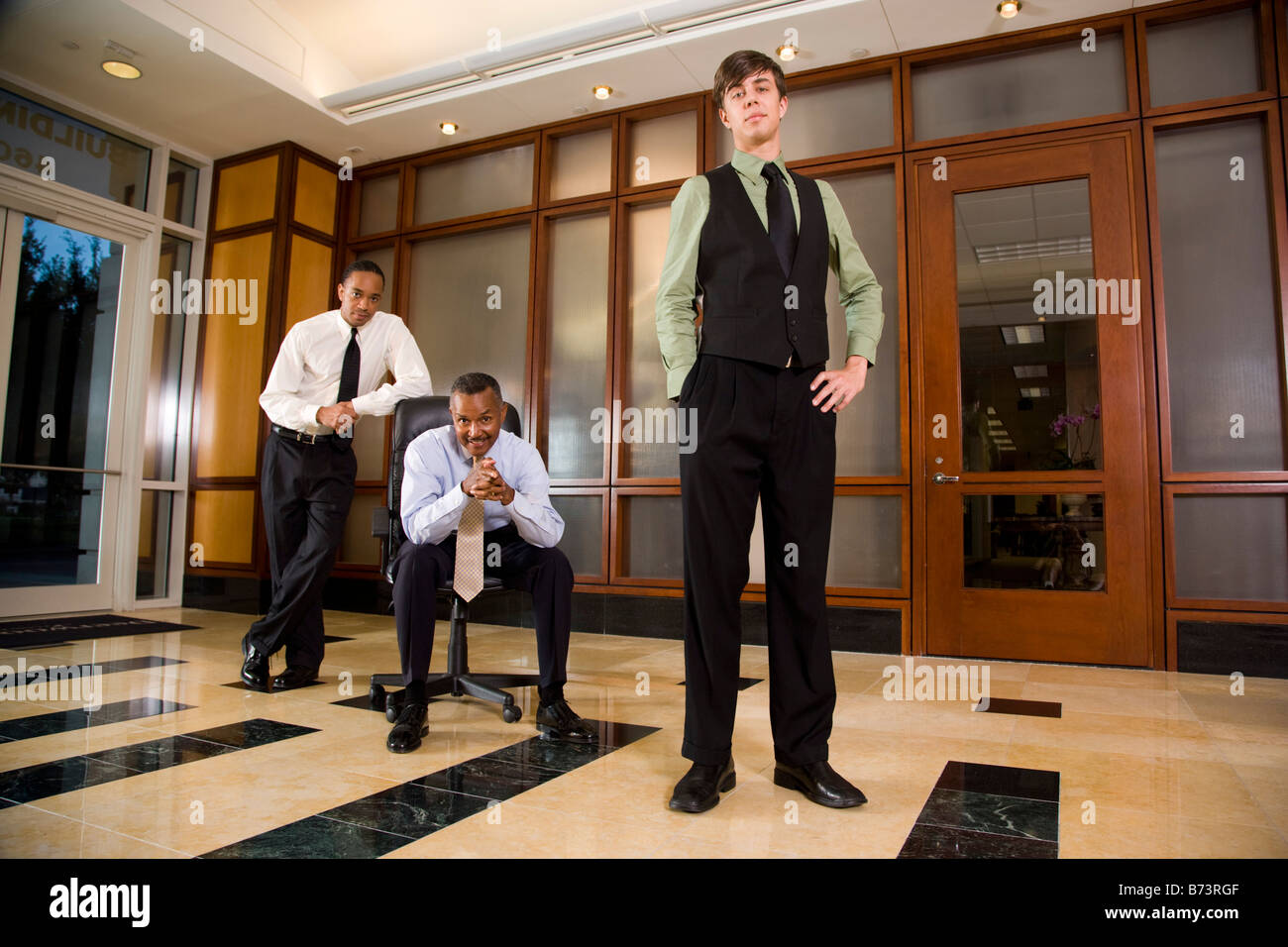 Executive and employees meeting in lobby Stock Photo - Alamy