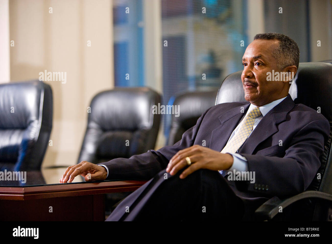 African-American executive sitting in conference room watching Stock ...