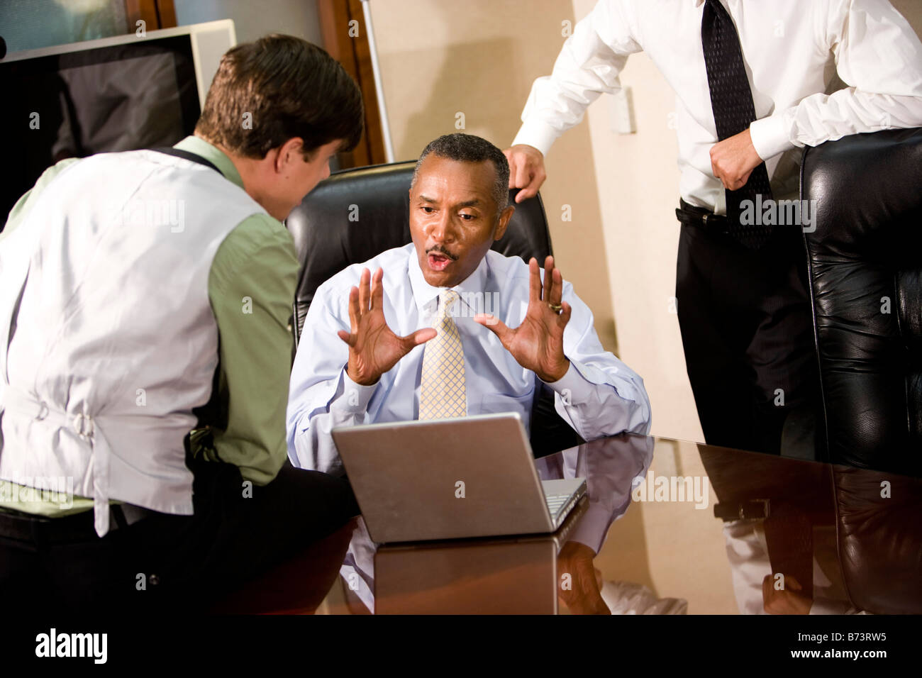 African-American executive in discussion with two businessmen Stock ...