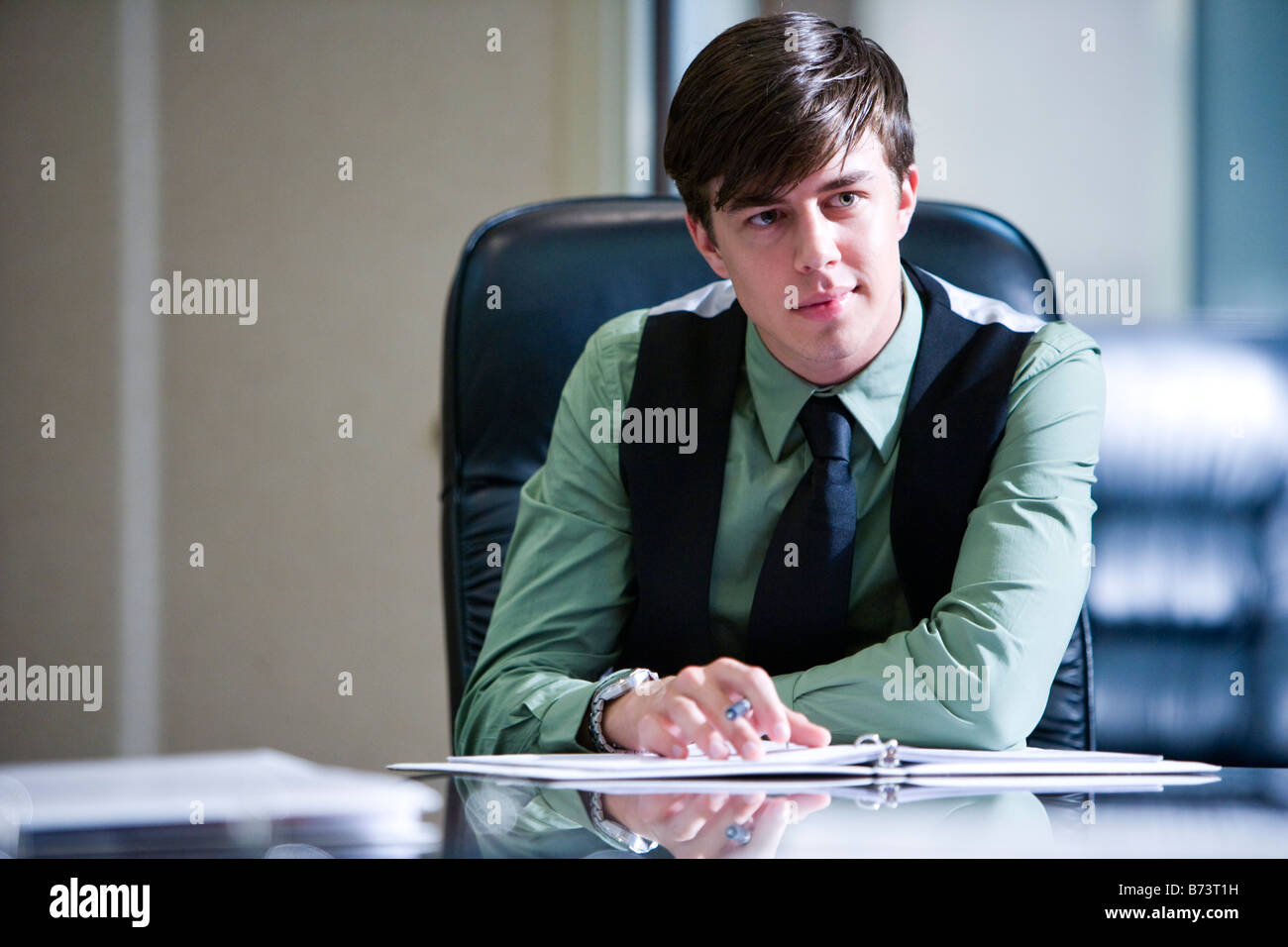 Young office worker reviewing paperwork Stock Photo - Alamy