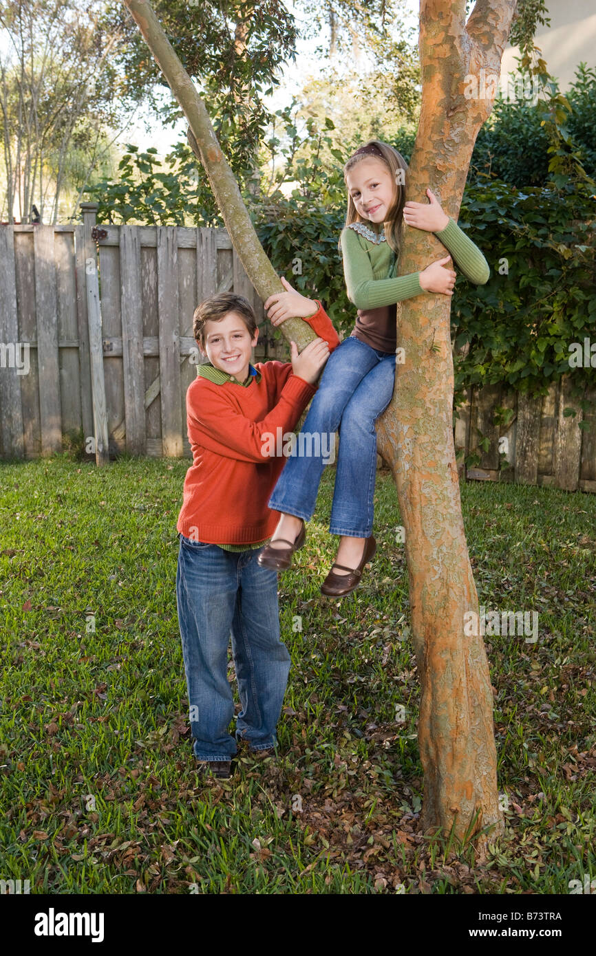 Girl in backyard climbing in tree hi-res stock photography and images ...