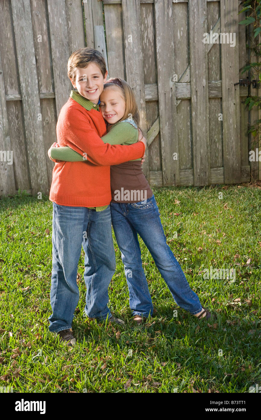 Children hugging in backyard Stock Photo - Alamy