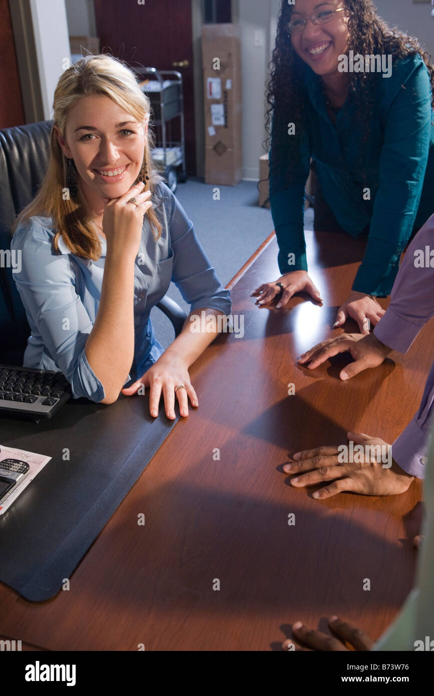 Office workers meeting around desk Stock Photo - Alamy