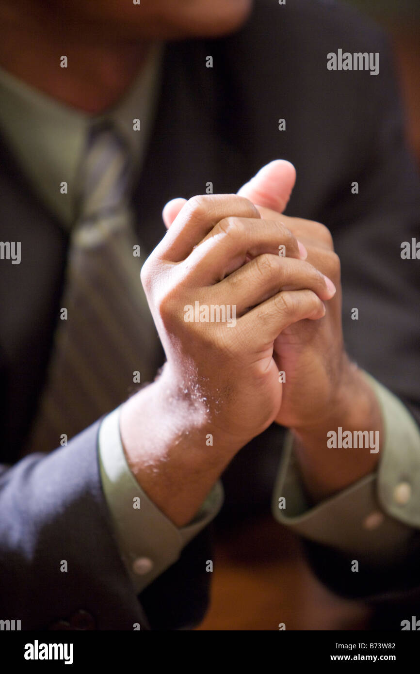 Close-up of clasped hands of businessman Stock Photo - Alamy