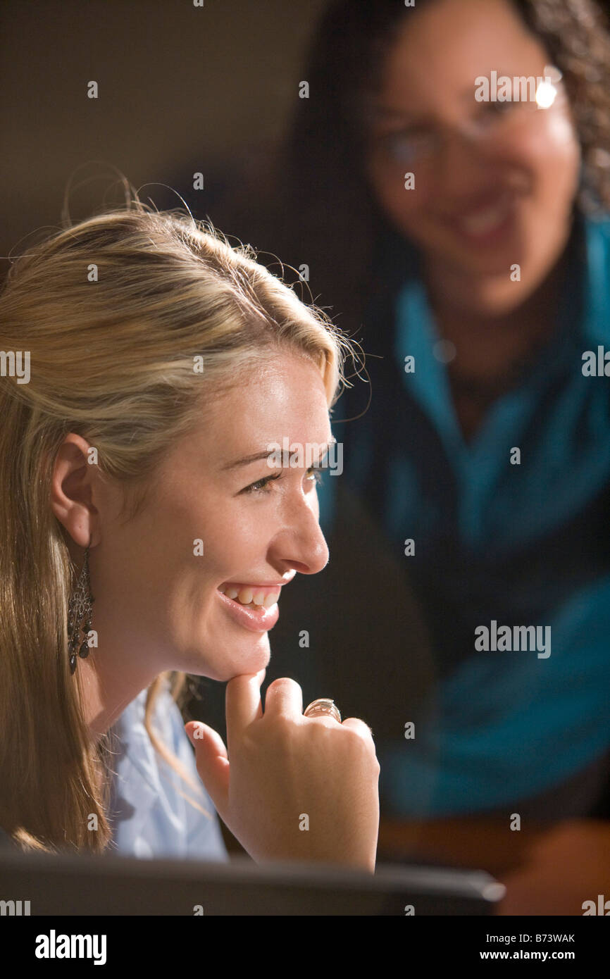 Profile of female office worker sitting at desk Stock Photo - Alamy