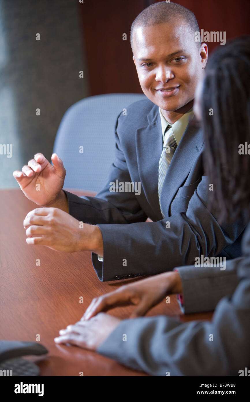 Two African-American businessmen conversing in boardroom meeting Stock ...