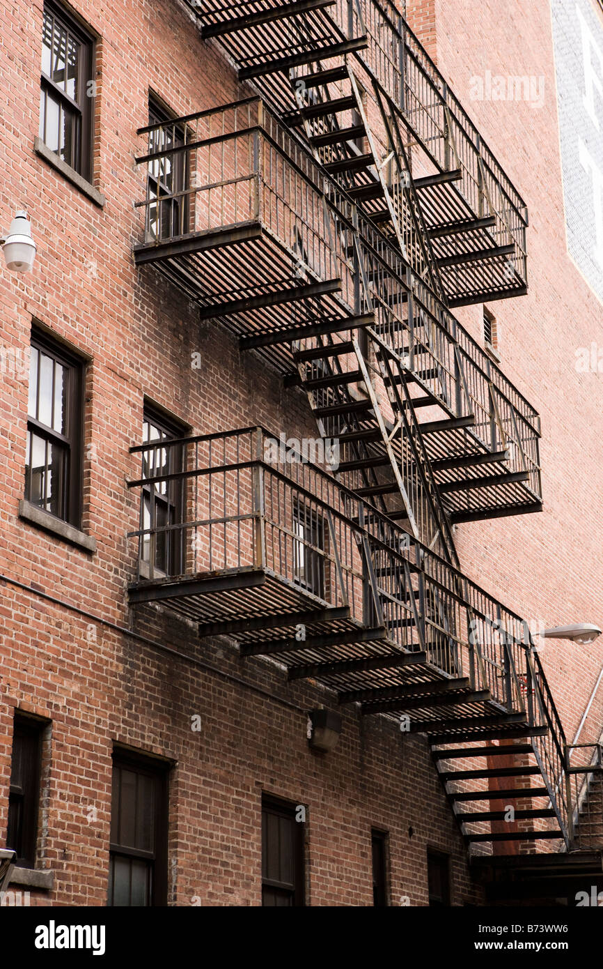 Urban scene of fire escapes and stairs on side of building Stock Photo ...