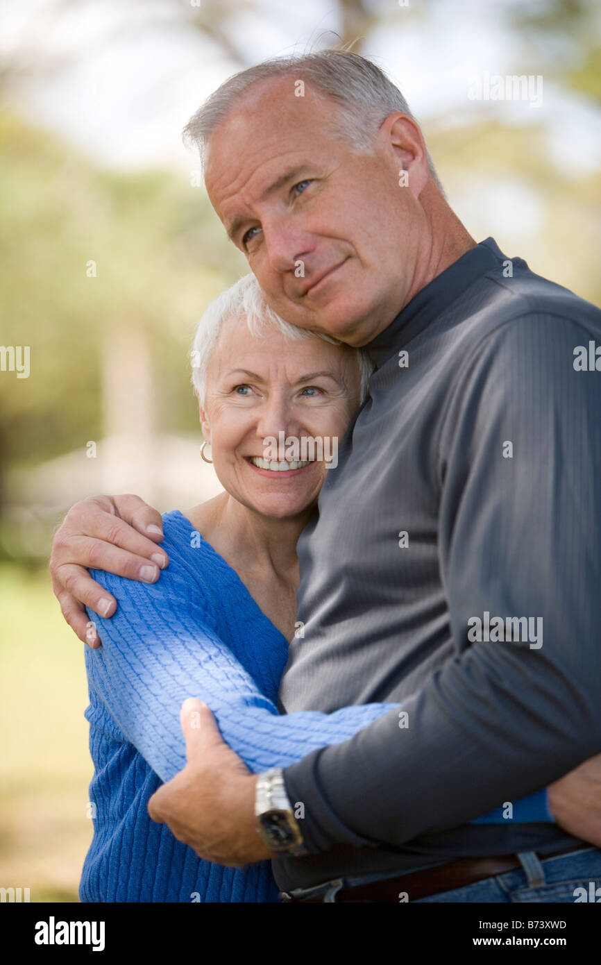 Senior couple hugging outdoors, smiling, side view Stock Photo - Alamy