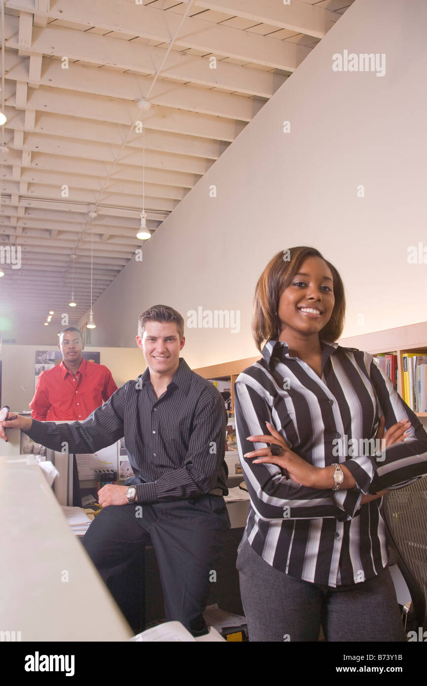 Multi-racial office workers standing at cubicle desk Stock Photo - Alamy