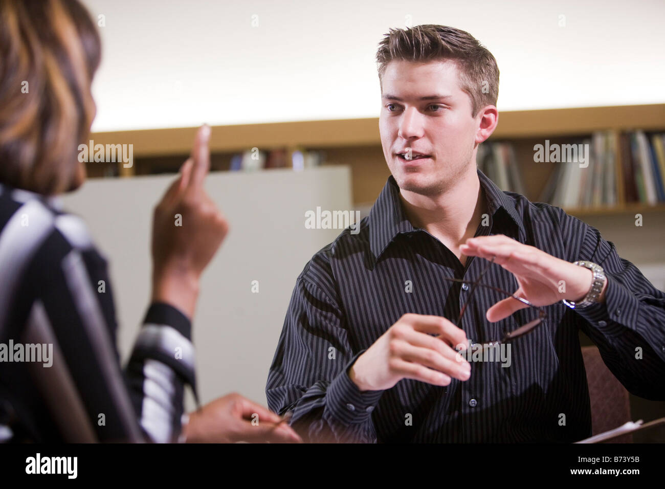 Two office workers having discussion Stock Photo - Alamy