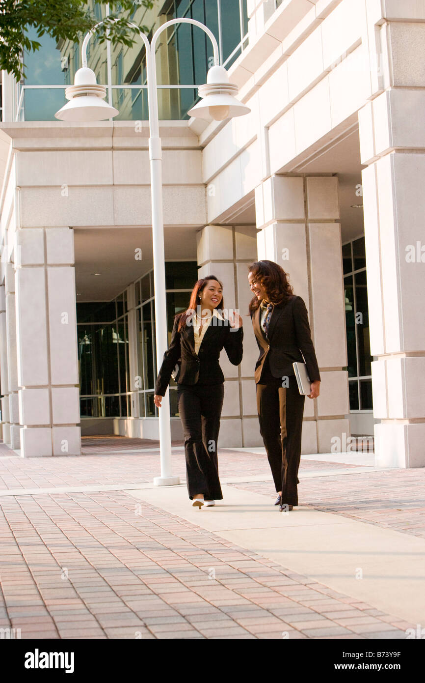 Two businesswomen walking outside office building Stock Photo - Alamy