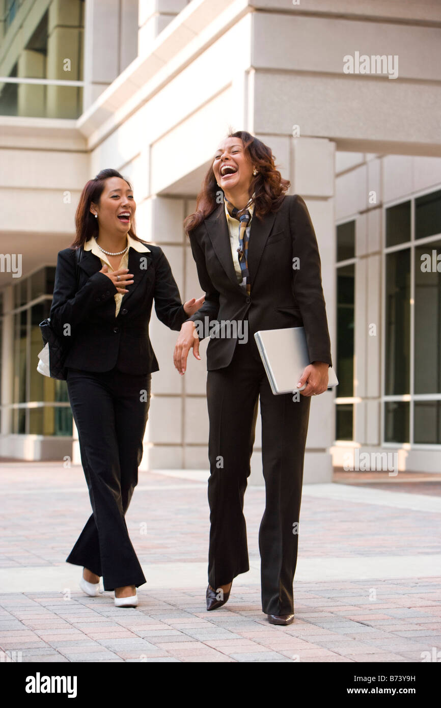 Two businesswomen walking outside office building Stock Photo - Alamy