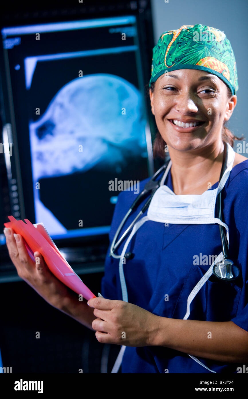 Veterinarian holding medical chart with animal x-rays in background ...
