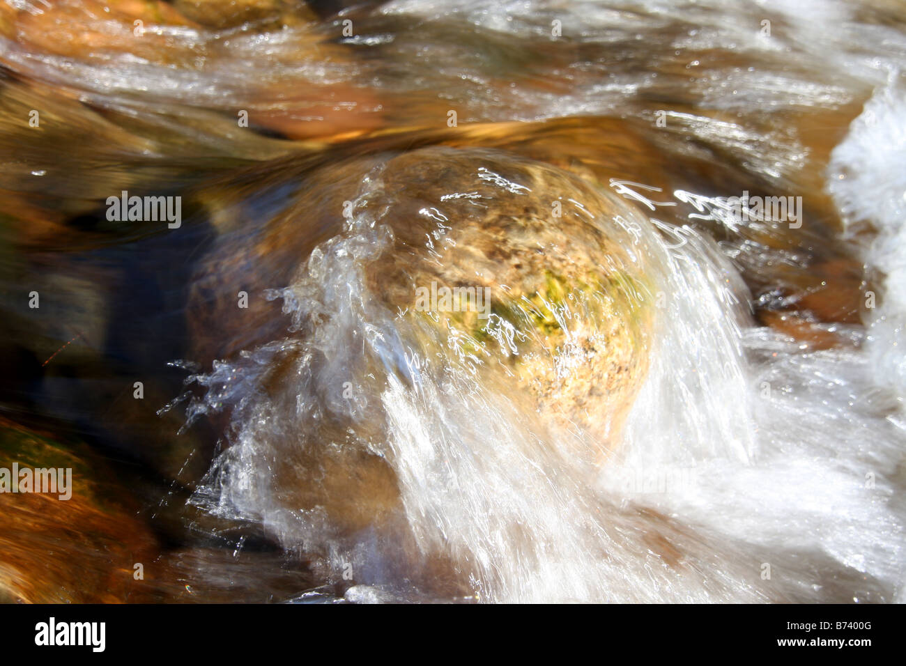 Water flowing over stones in river Stock Photo - Alamy
