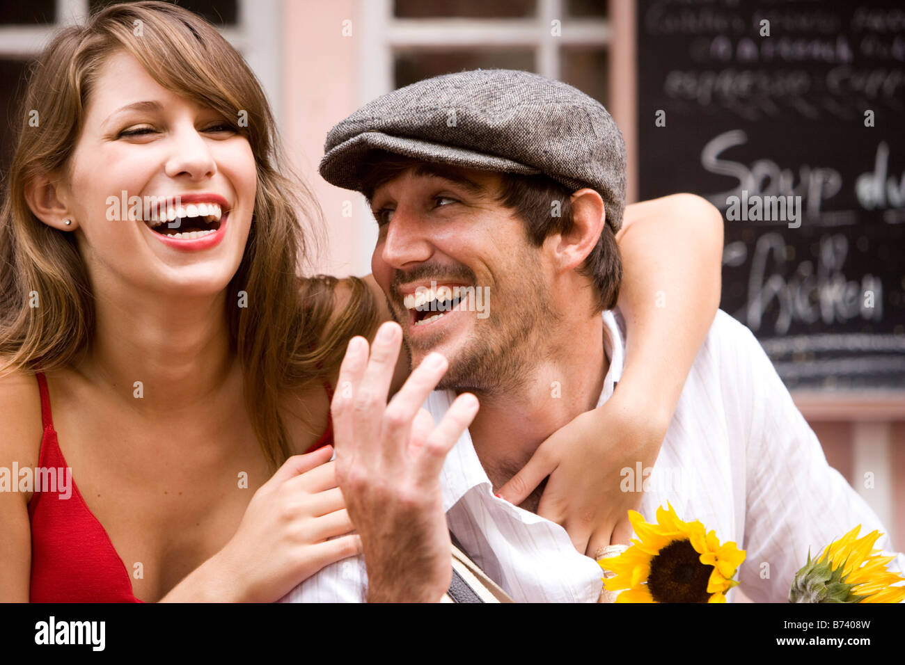 Close up of attractive young couple talking outside restaurant Stock ...