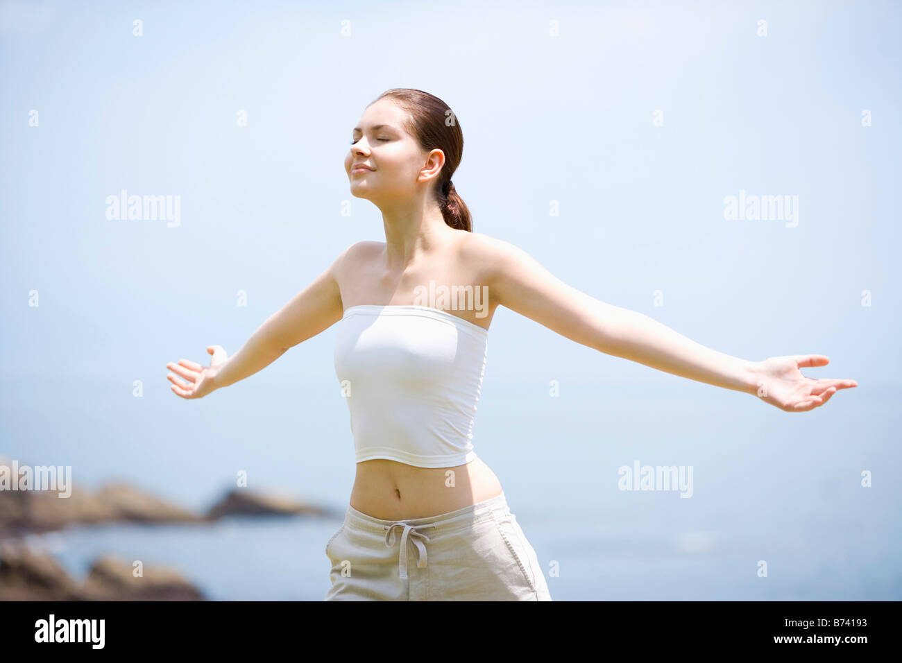 Young woman with arms outstretched Stock Photo - Alamy