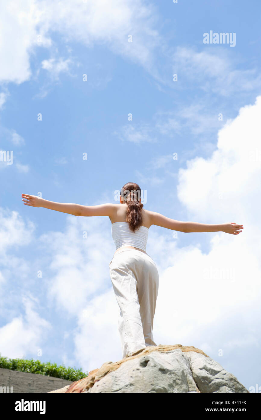 Young woman with arms outstretched rear view Stock Photo - Alamy