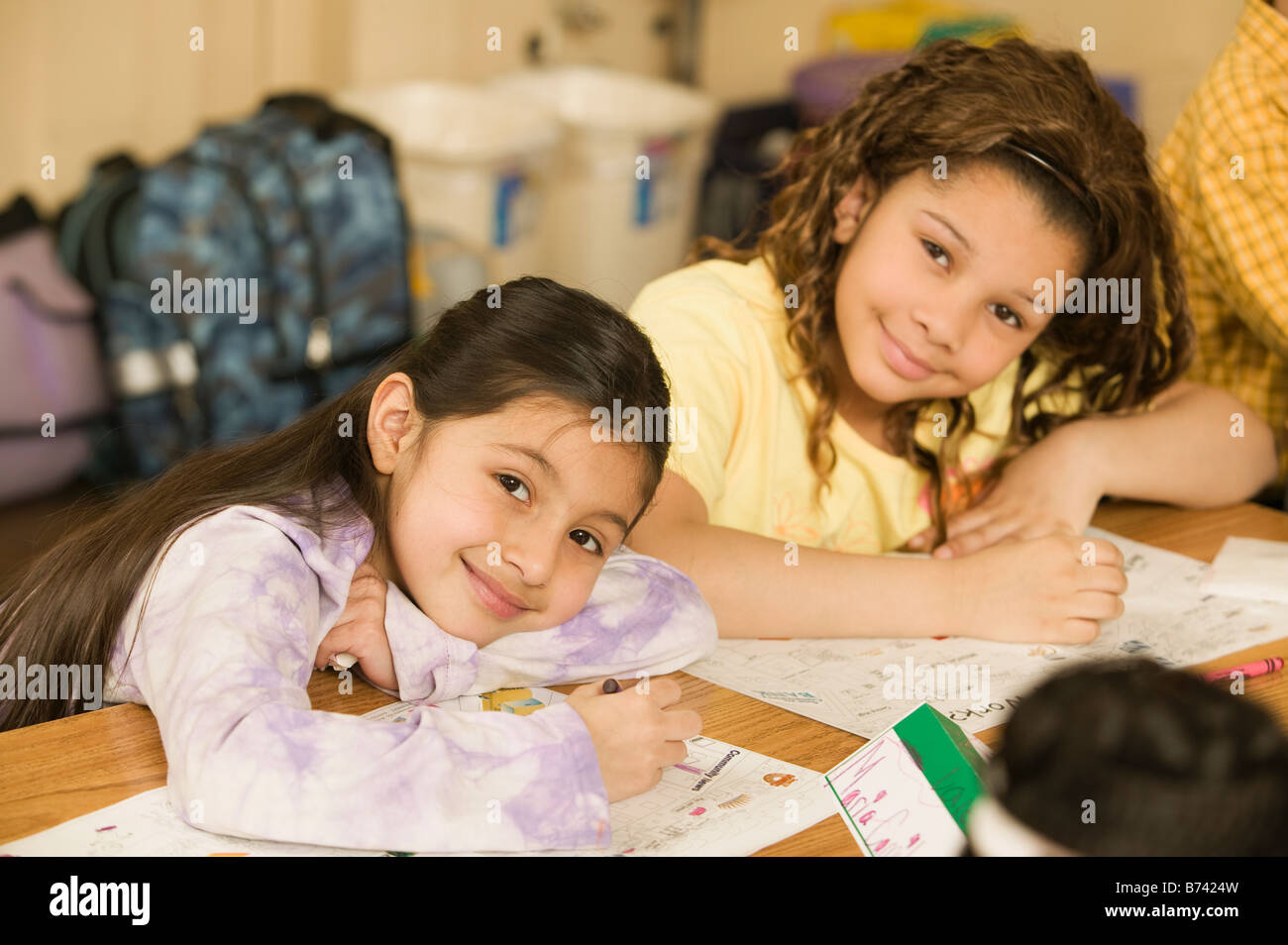 School girls writing at desks Stock Photo - Alamy